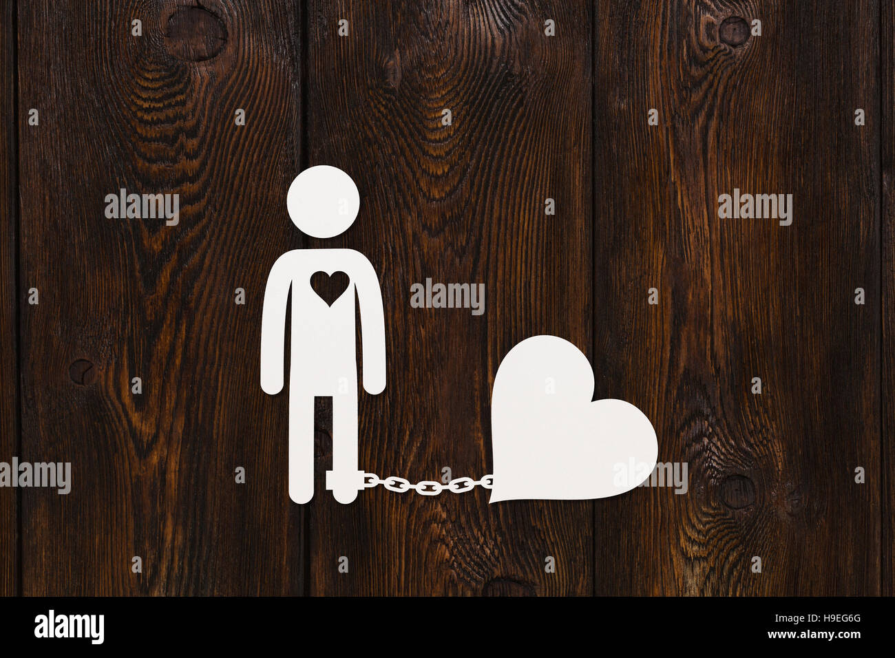 Paper man chained to heart, love concept, abstract conceptual image ...