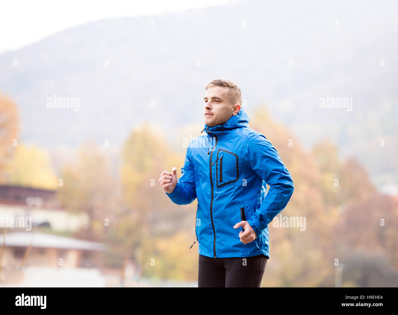 Young athlete in park running in colorful autumn nature Stock Photo - Alamy
