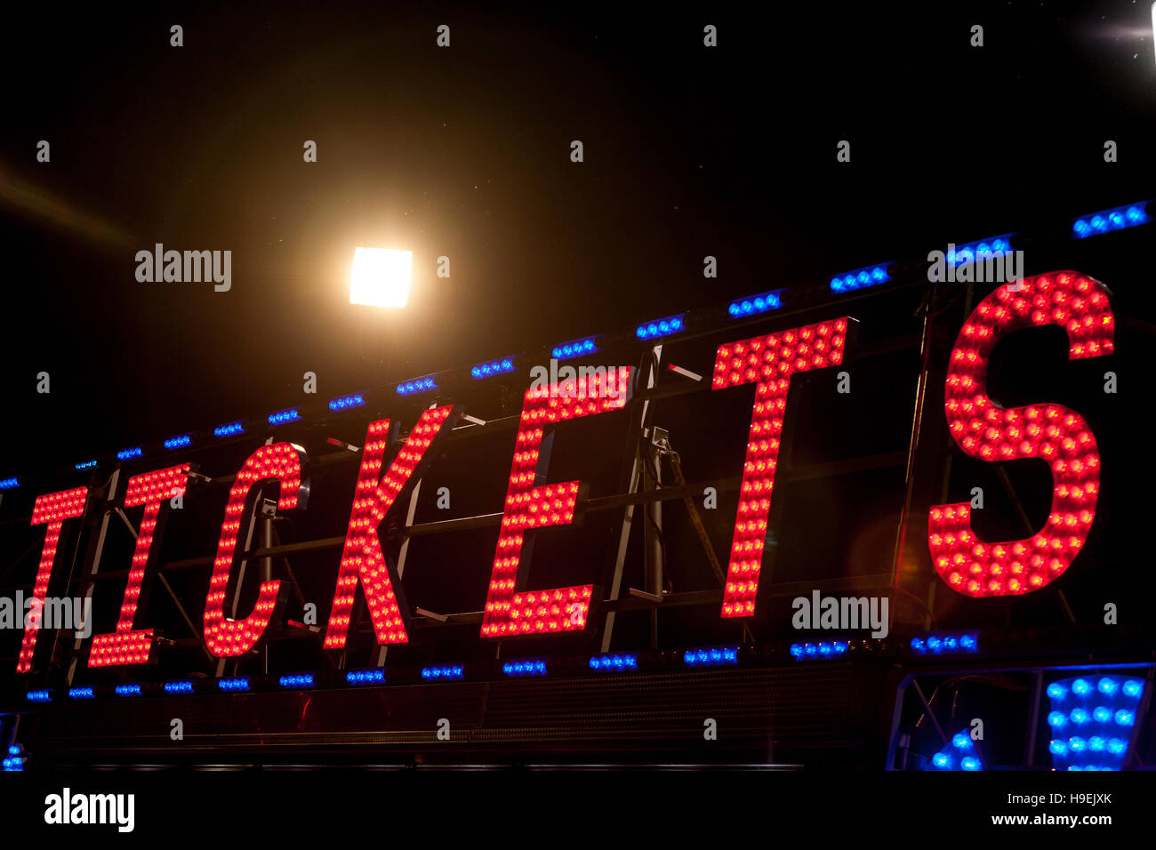electric TICKETS sign on a scaffolding in circus-style during the night ...