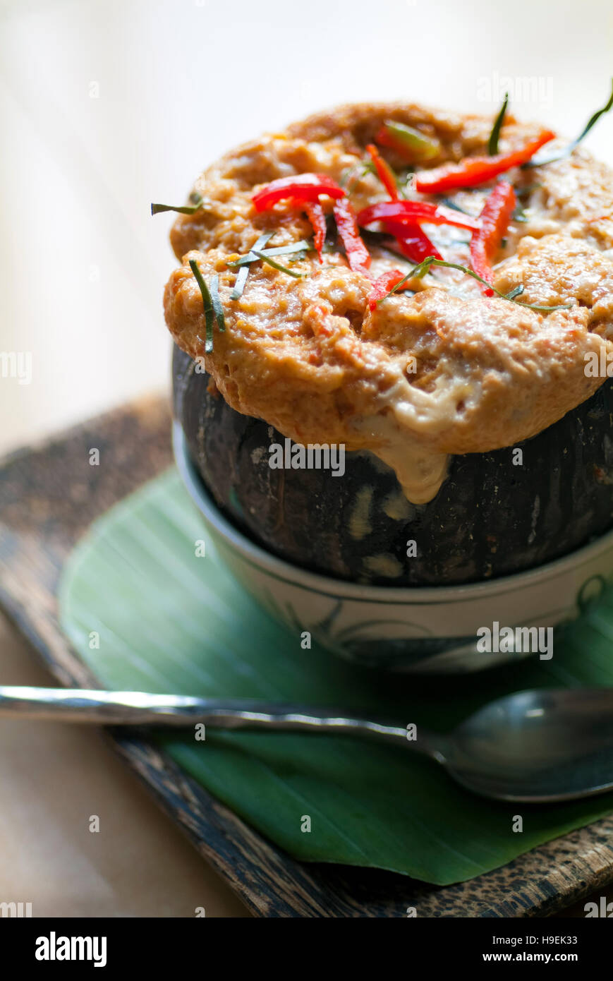 Fish amok, a traditional fish curry, here cooked in a coconut shell ...