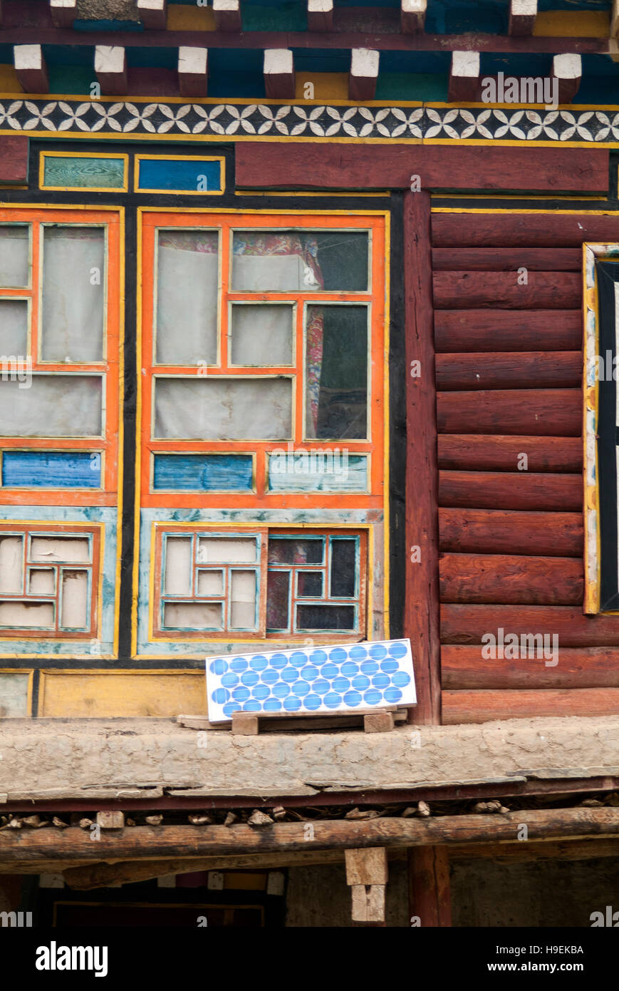 A window of a traditional wooden house with solar panel fueling a light ...