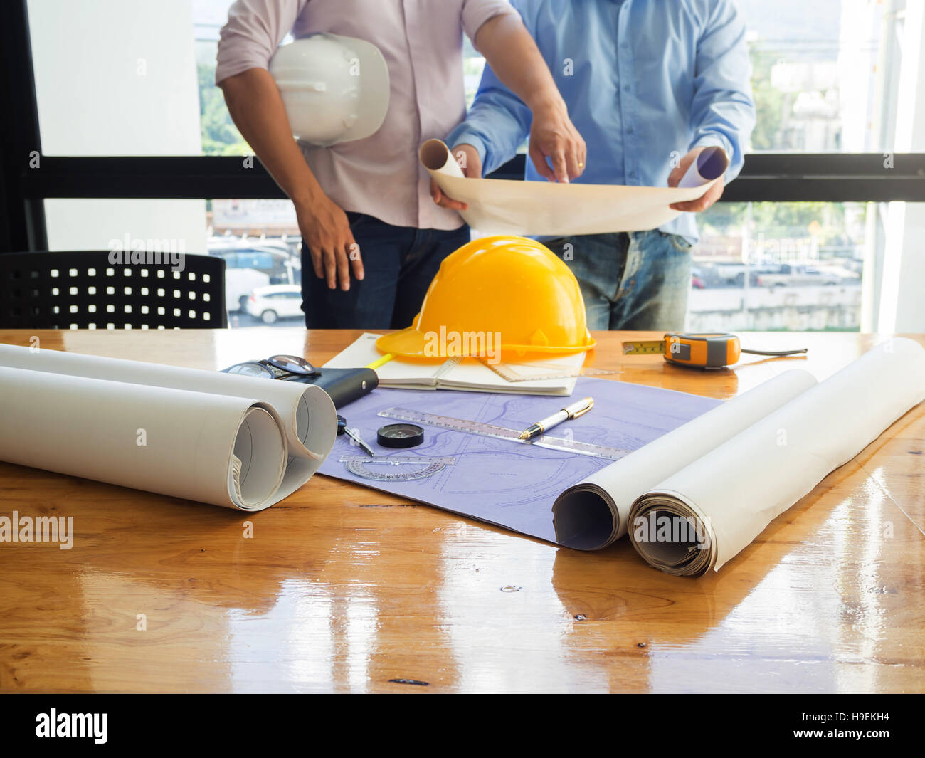 Architect concept, Architects working with blueprints in the office ...