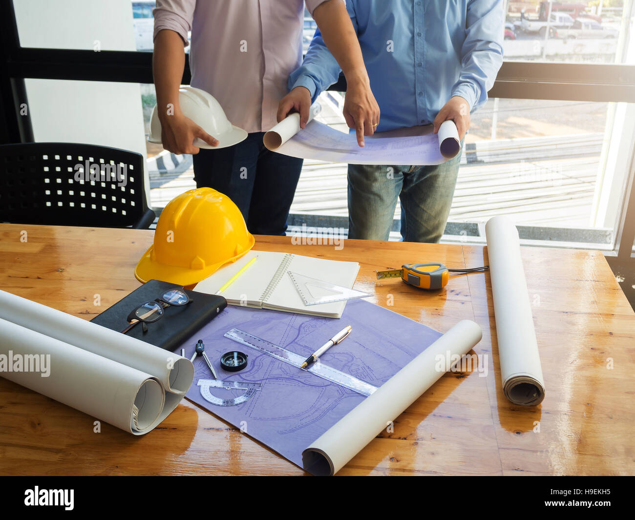 Architect concept, Architects working with blueprints in the office ...