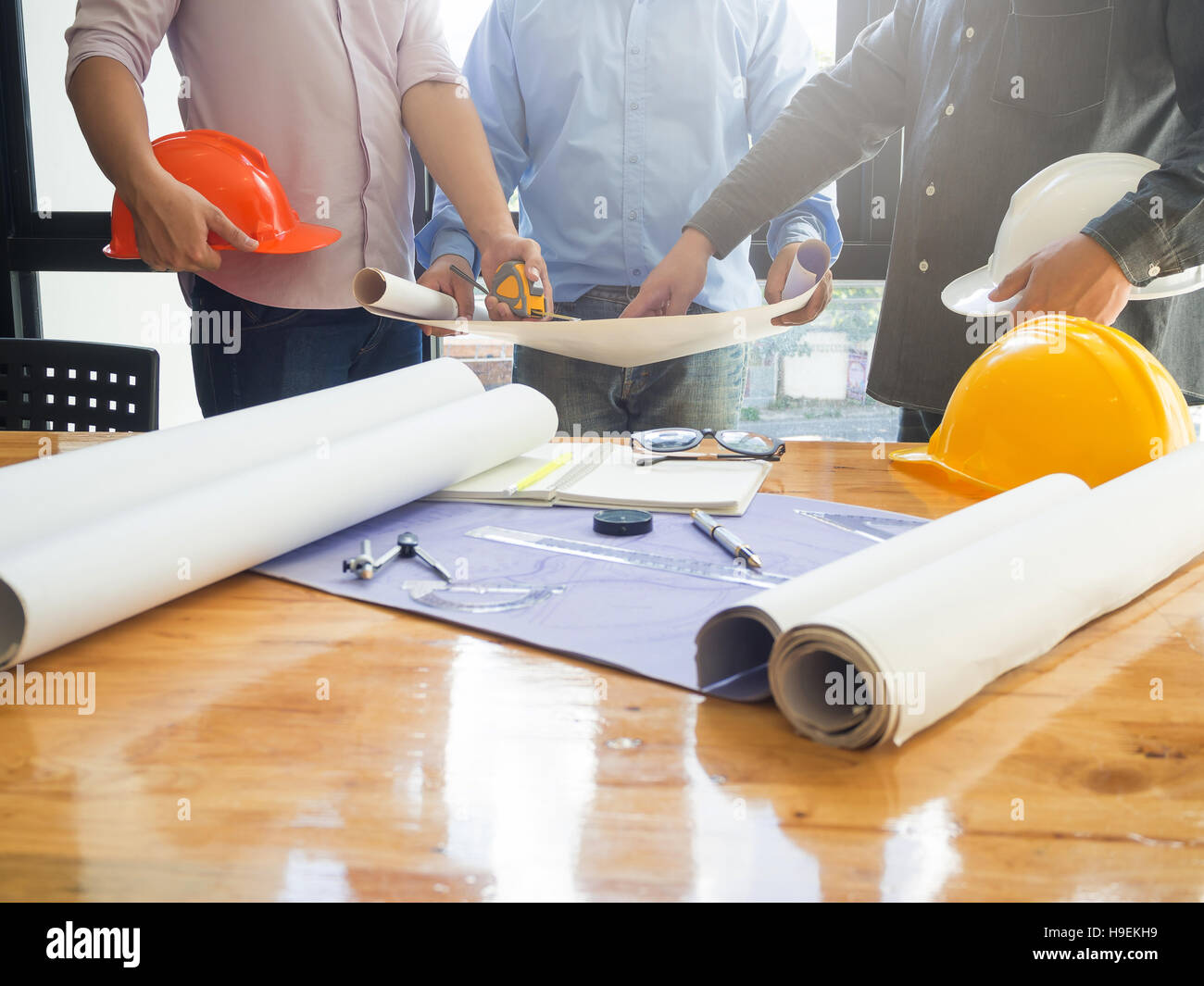 Architect concept, Architects working with blueprints in the office ...