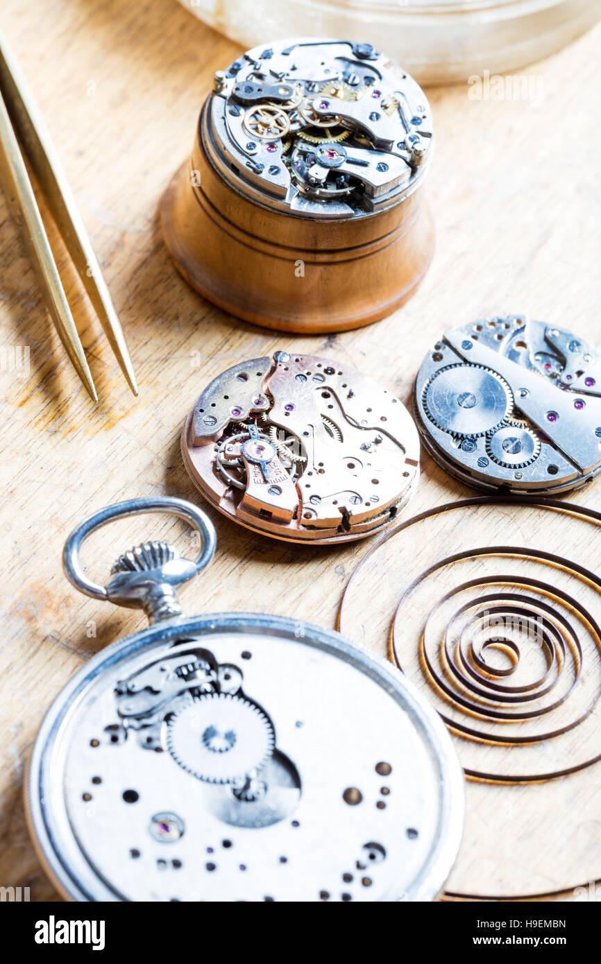 opened clocks and internals on the watchmaker table Stock Photo - Alamy
