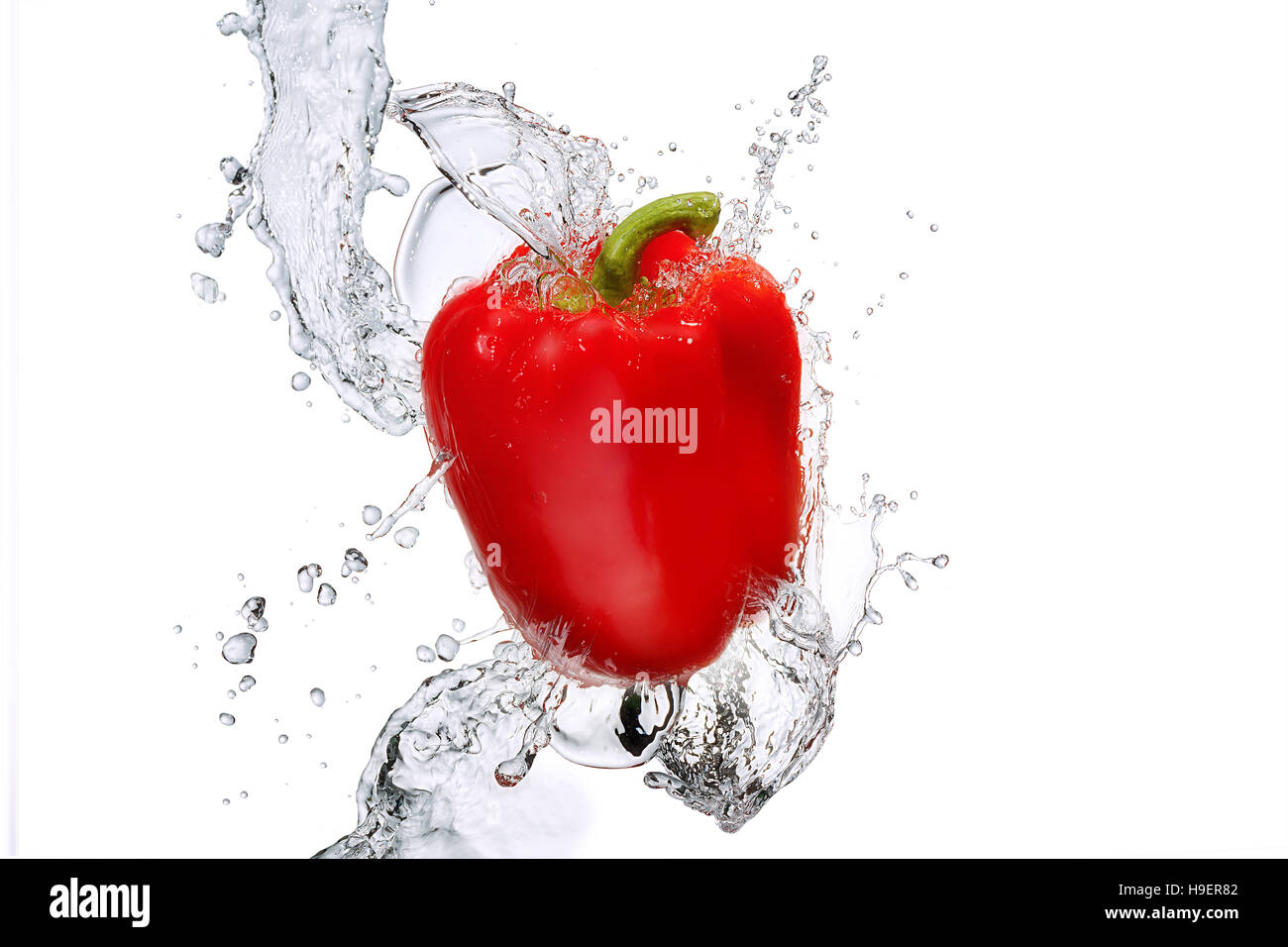 Water splash with bell pepper isolated Stock Photo - Alamy