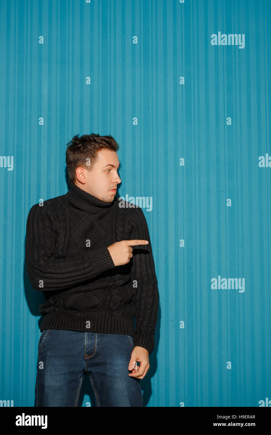 Portrait of young man with serious facial expression showing to the ...