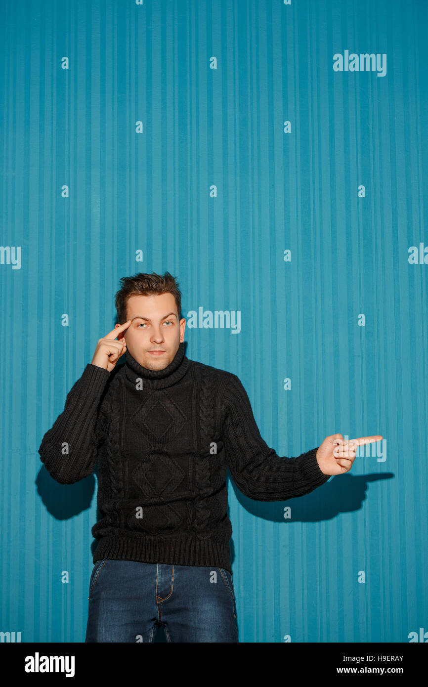 Portrait of young man with serious facial expression showing to the ...