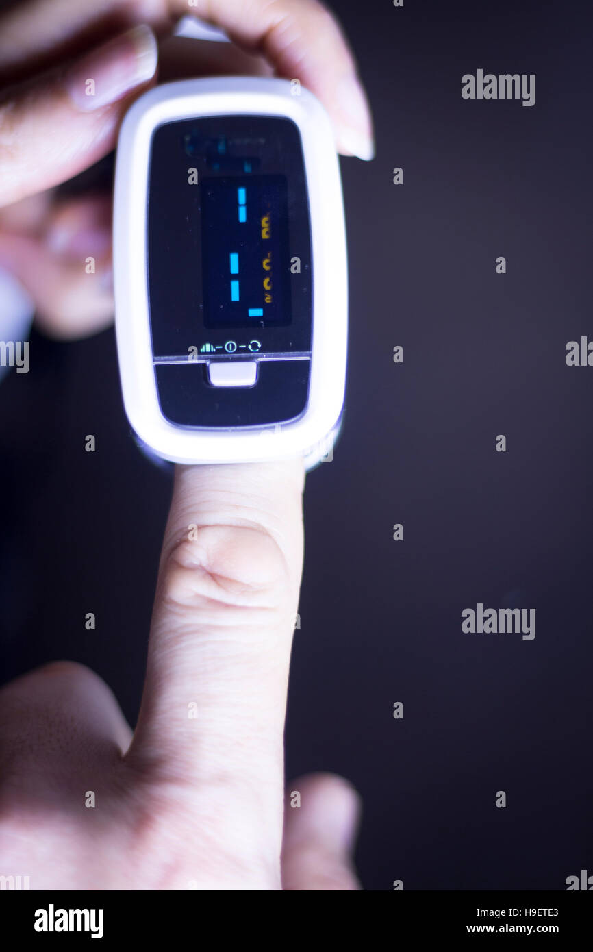 Portable hand held domestic cardiac finger pulse rate meter to show ...