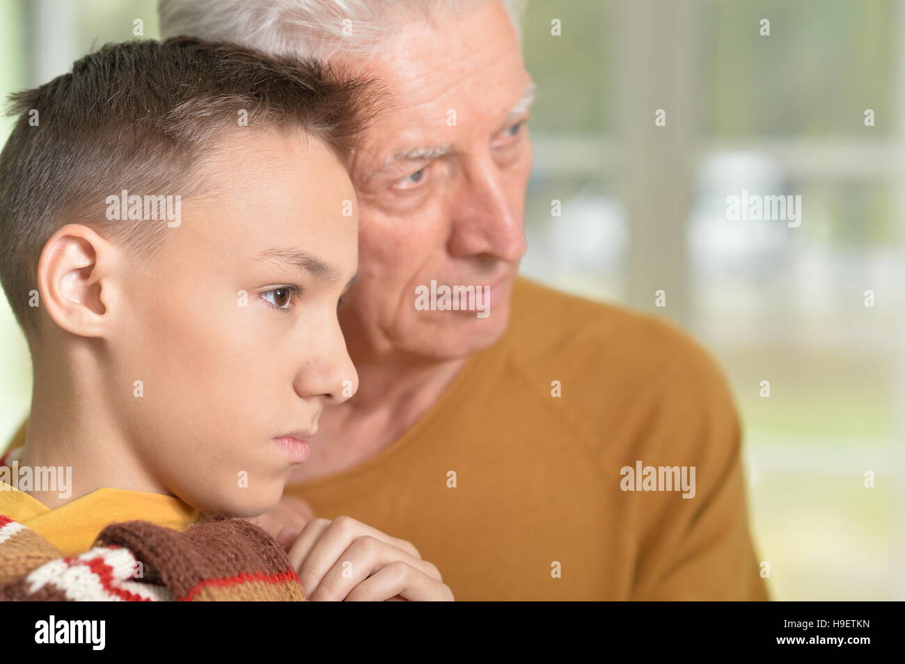 Thoughtful grandfather and grandson Stock Photo - Alamy