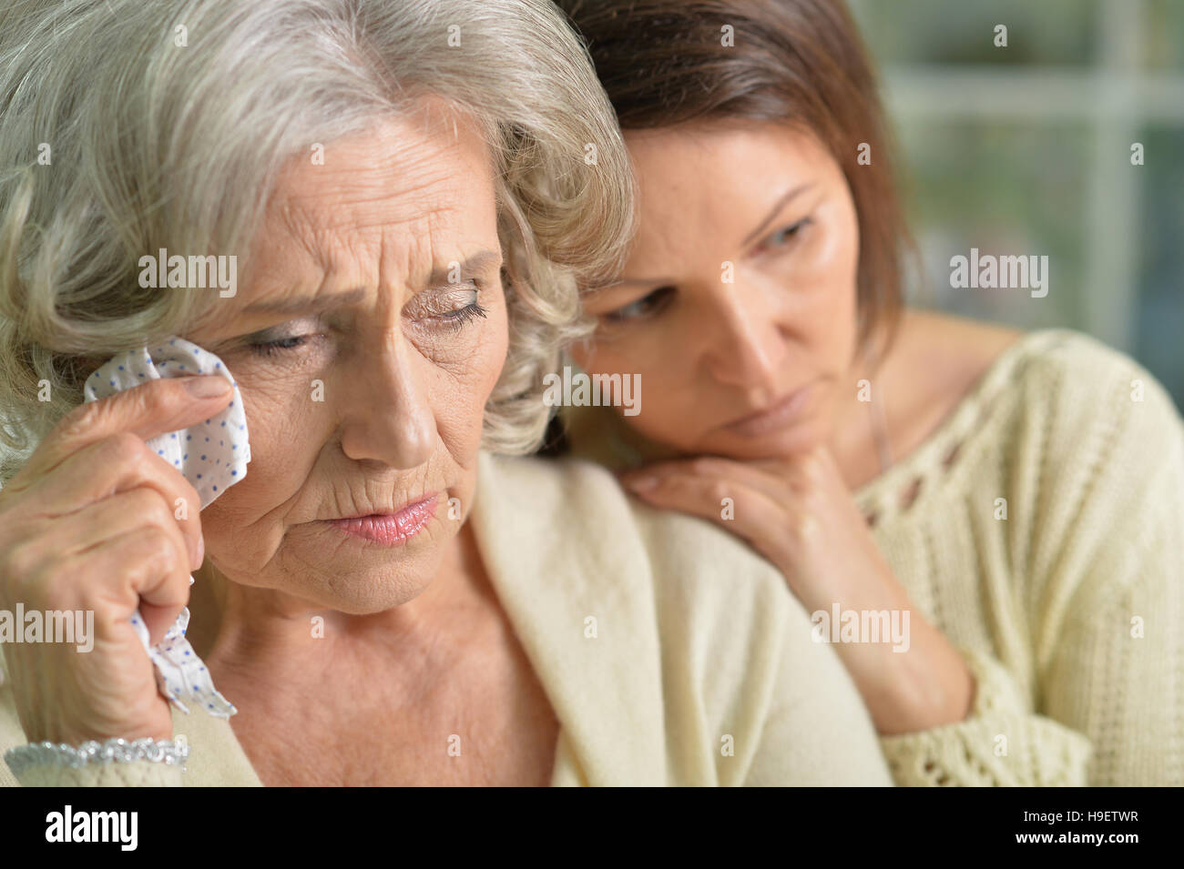 Sad senior and young women Stock Photo - Alamy