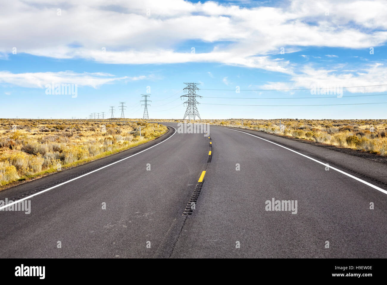 An empty rural highway with electric poles Stock Photo - Alamy