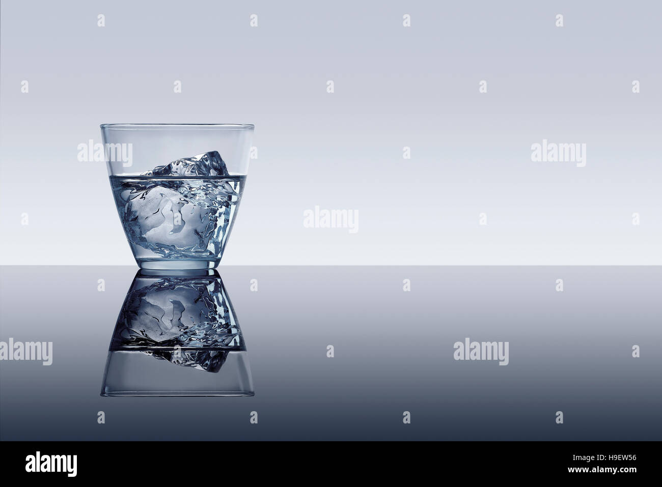 Ice cube in glass of water Stock Photo - Alamy
