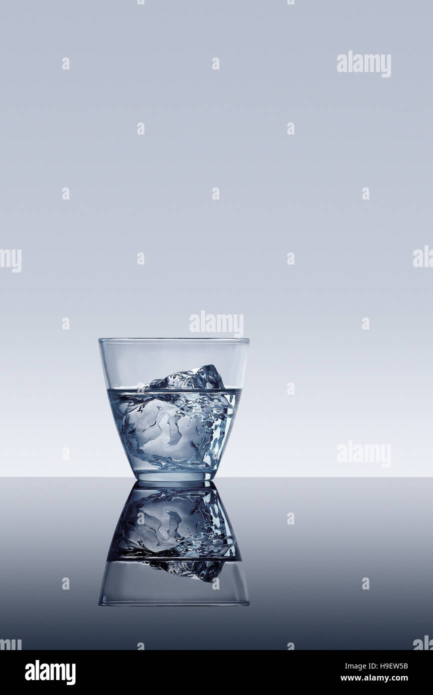 Ice cube in glass of water Stock Photo - Alamy