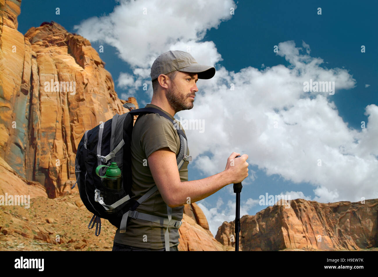 Caucasian hiker holding walking stick in desert landscape Stock Photo ...