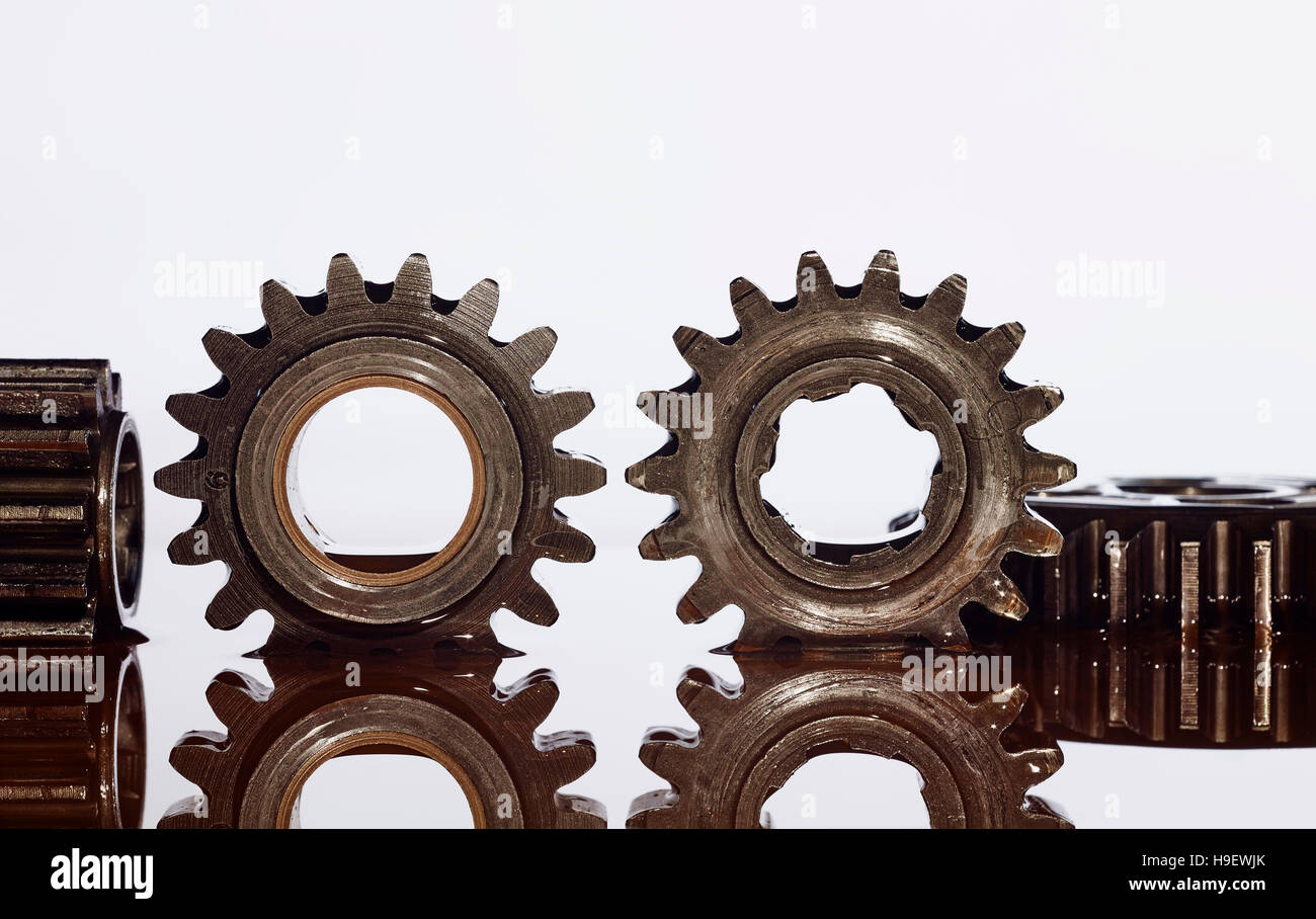 Gears in puddle of oil Stock Photo - Alamy