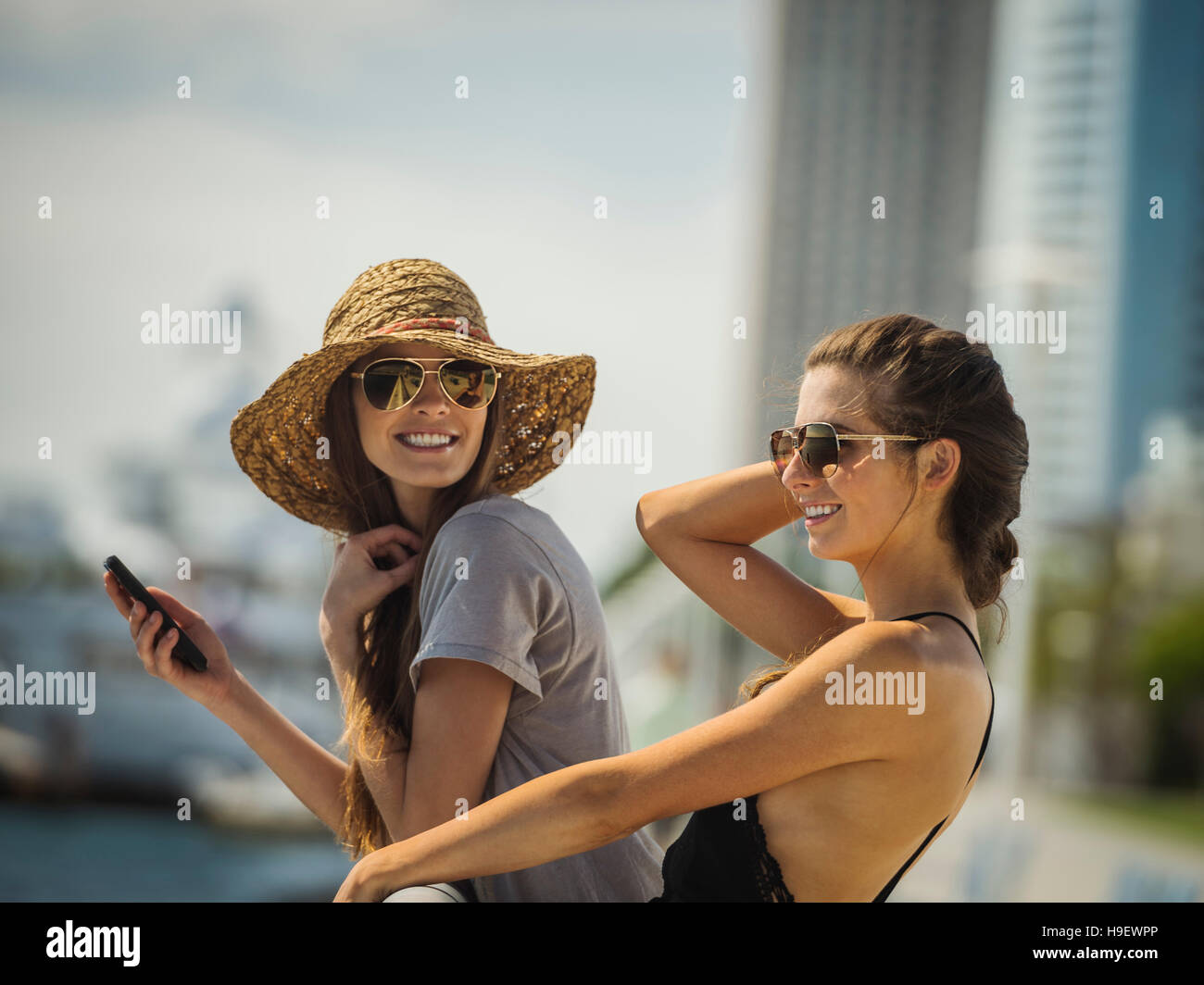 Caucasian women leaning on railing Stock Photo - Alamy
