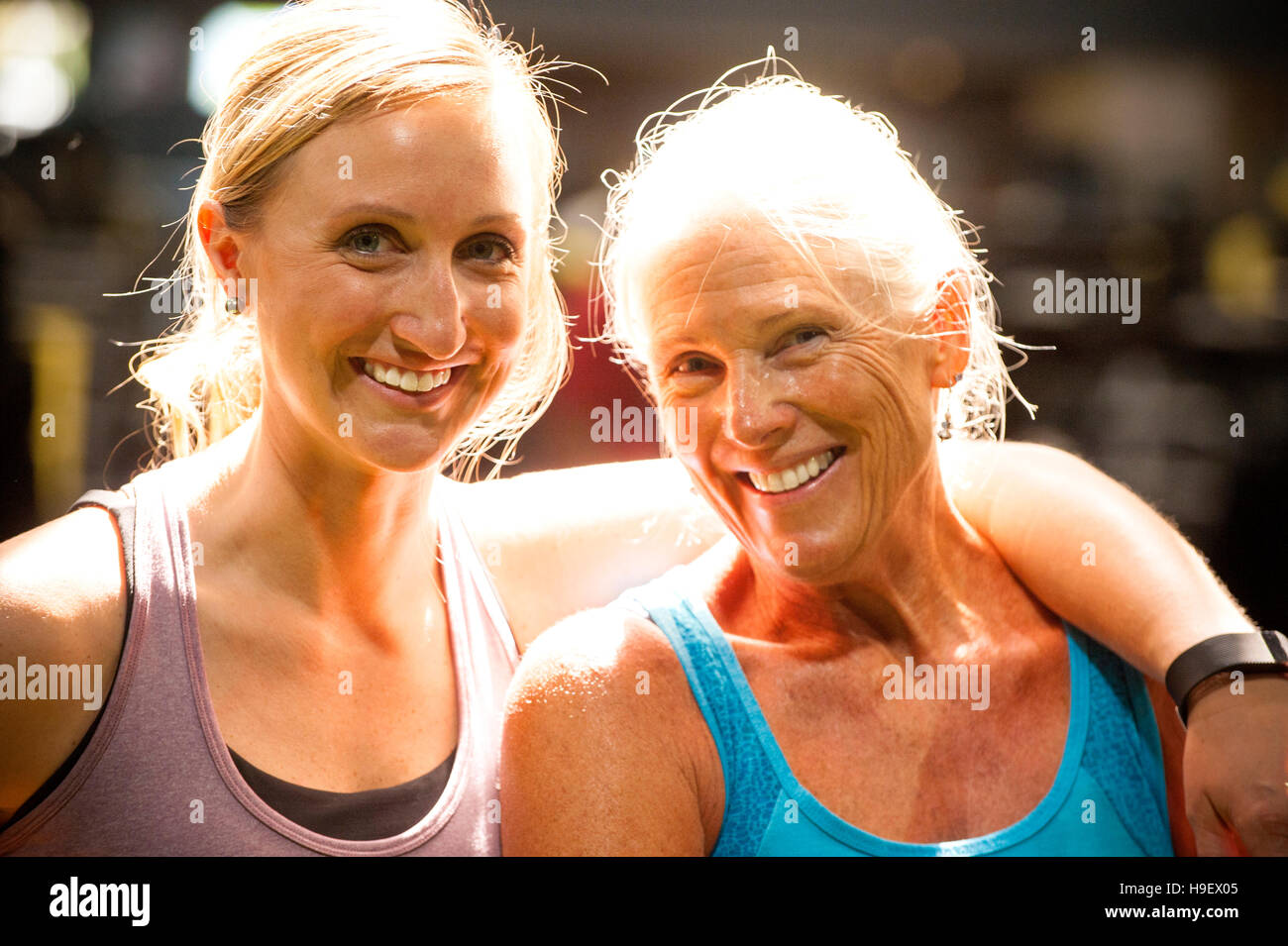 Portrait of smiling women hugging Stock Photo - Alamy