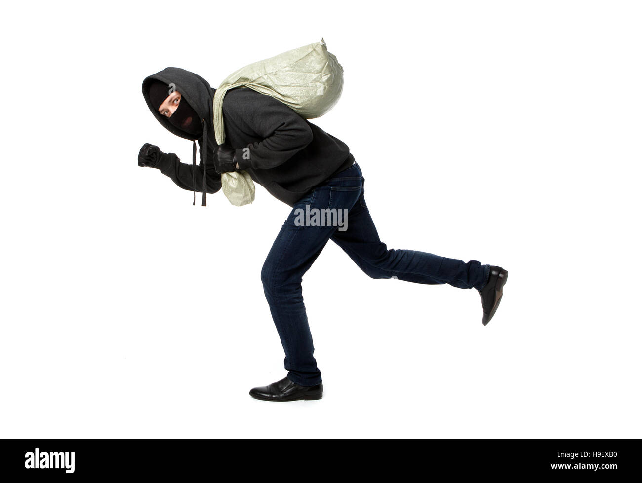 Thief in jacket with hood Stock Photo - Alamy