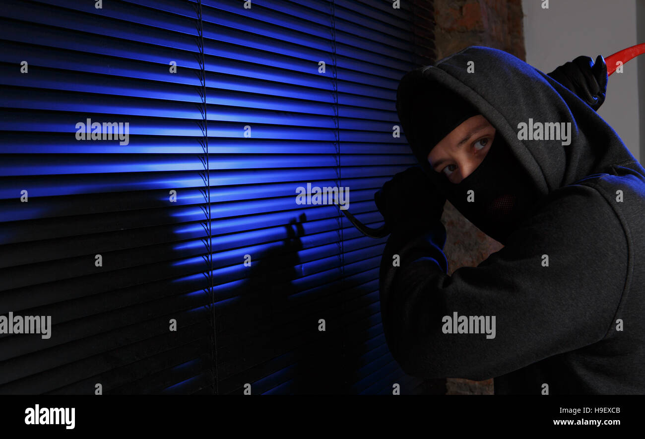 Robber trying open window night Stock Photo - Alamy