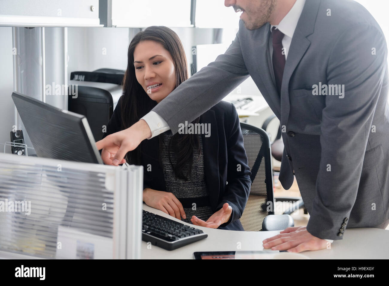 Business people talking in office using computer Stock Photo - Alamy
