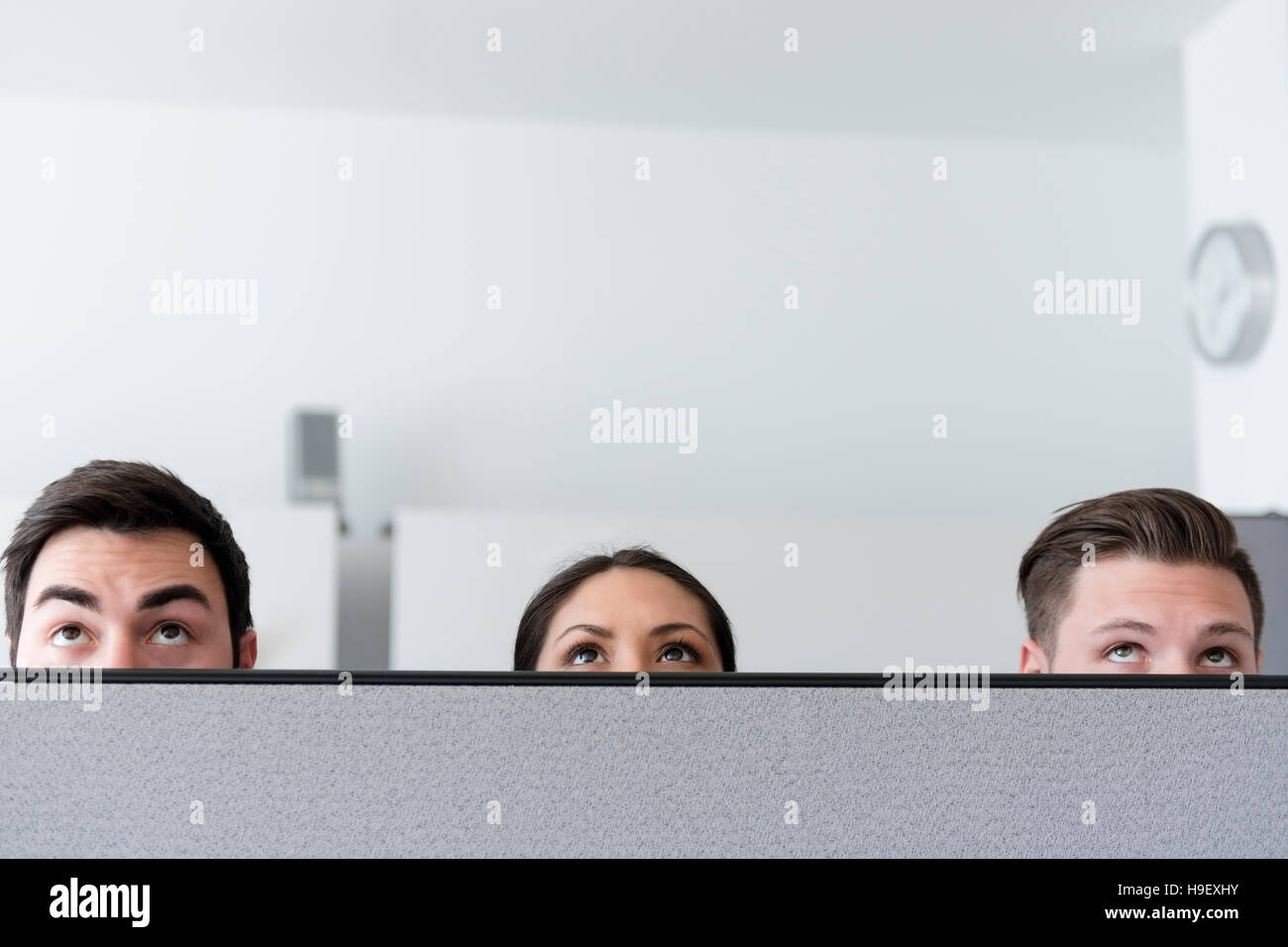 Man peeking over cubicle wall hi-res stock photography and images - Alamy