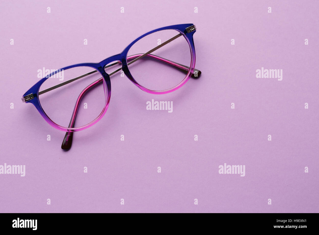 Multi-colored glasses in purple background Stock Photo - Alamy