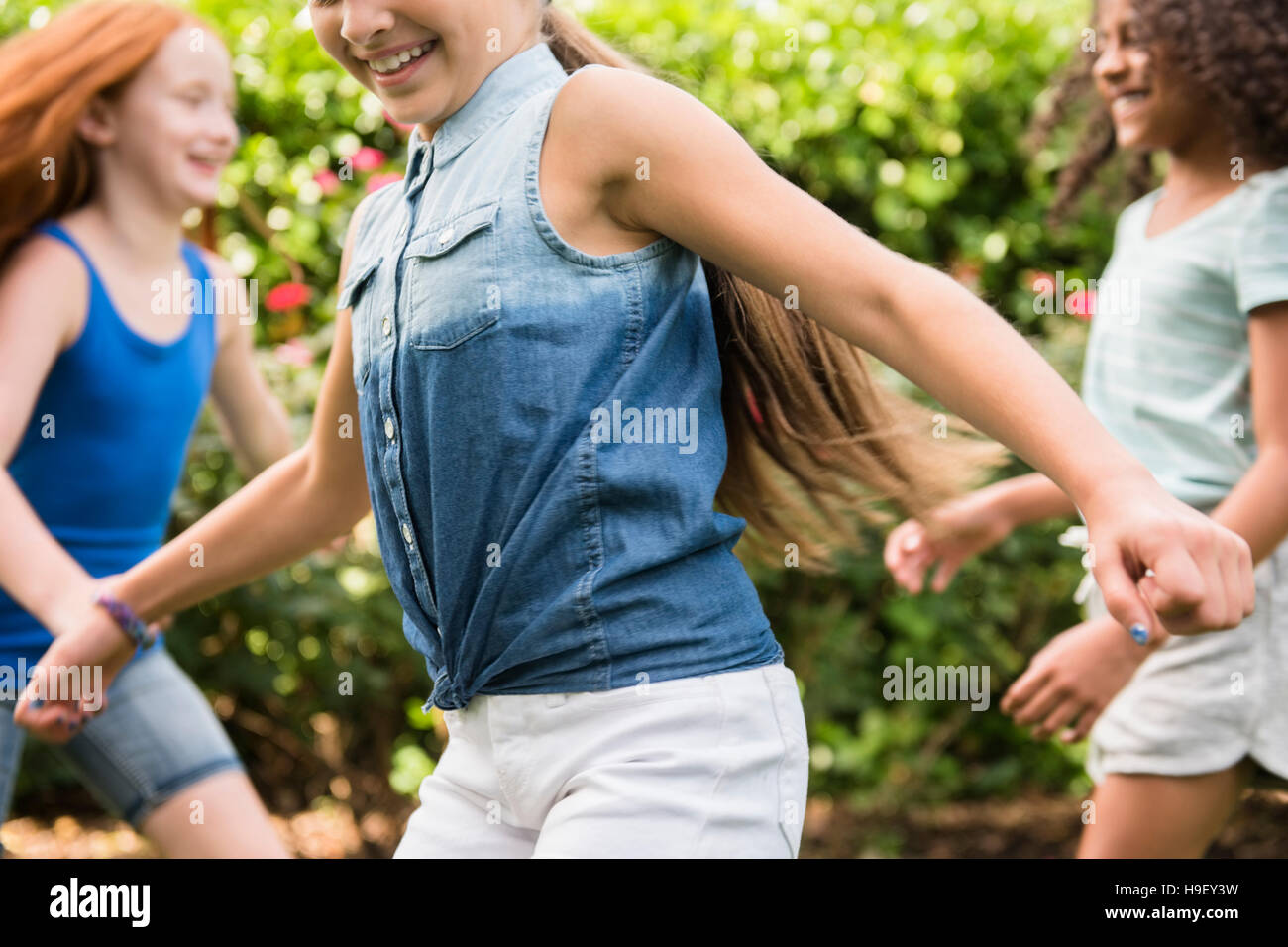 Smiling girls running outdoors Stock Photo - Alamy