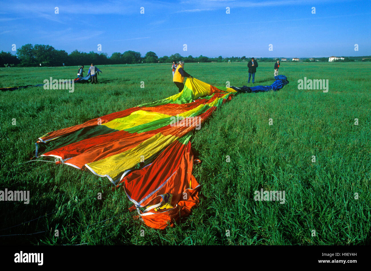 Deflated hot-air balloon on the ground near Castiglione del Lago ...