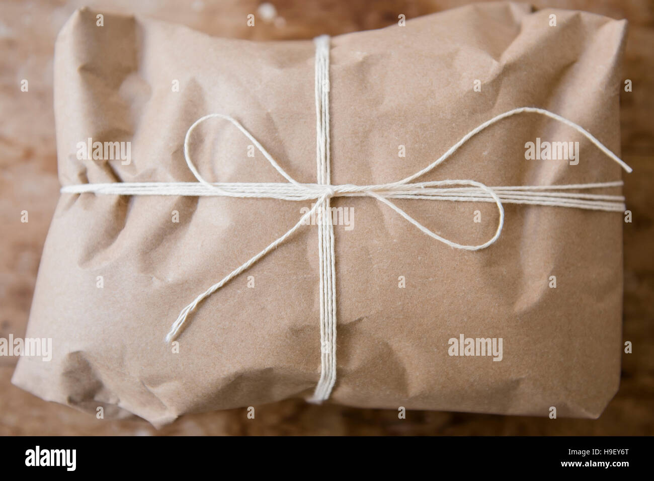 String tied around package wrapped in brown paper Stock Photo - Alamy