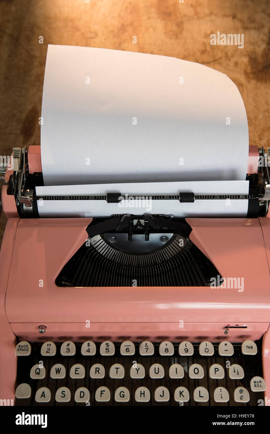 Blank paper in pink typewriter Stock Photo - Alamy