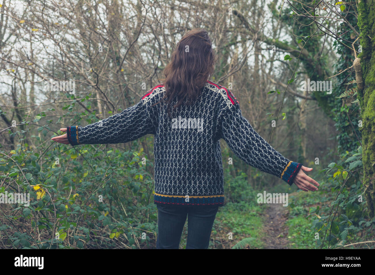 A young woman is expressing freedom and joy a she is walking in a ...