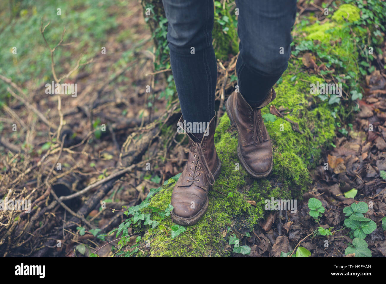 The feet of a young person wearing boots in nature Stock Photo - Alamy