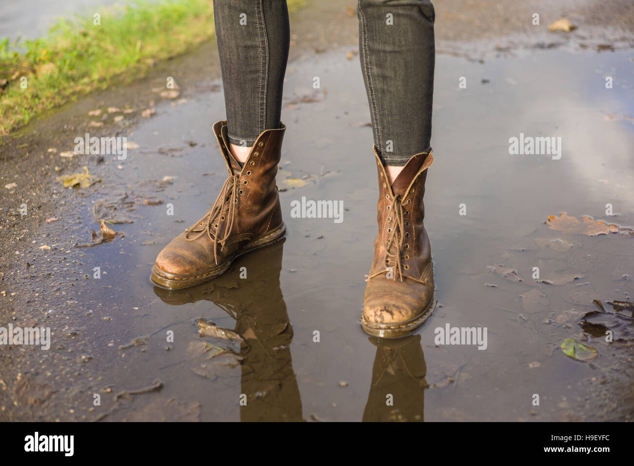 The feet of a young person standing in a puddle Stock Photo - Alamy