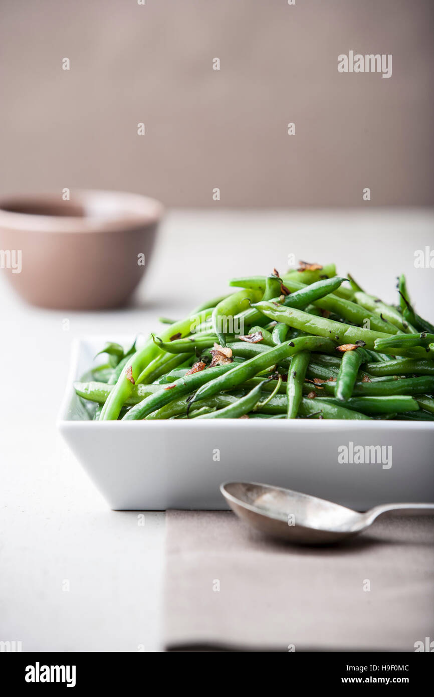 Pile of roasted green beans with spoon Stock Photo - Alamy