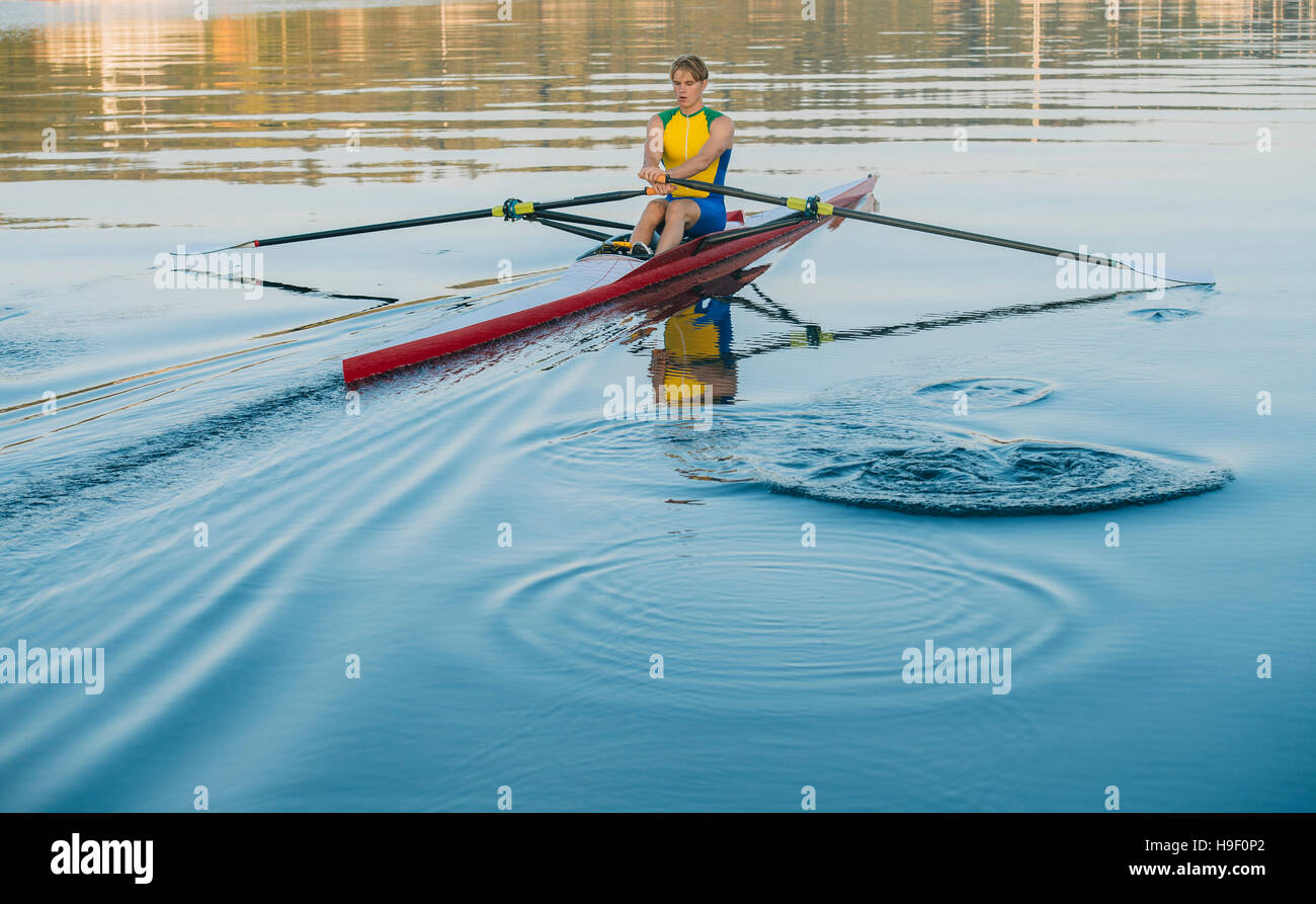 Caucasian man rowing on lake Stock Photo - Alamy