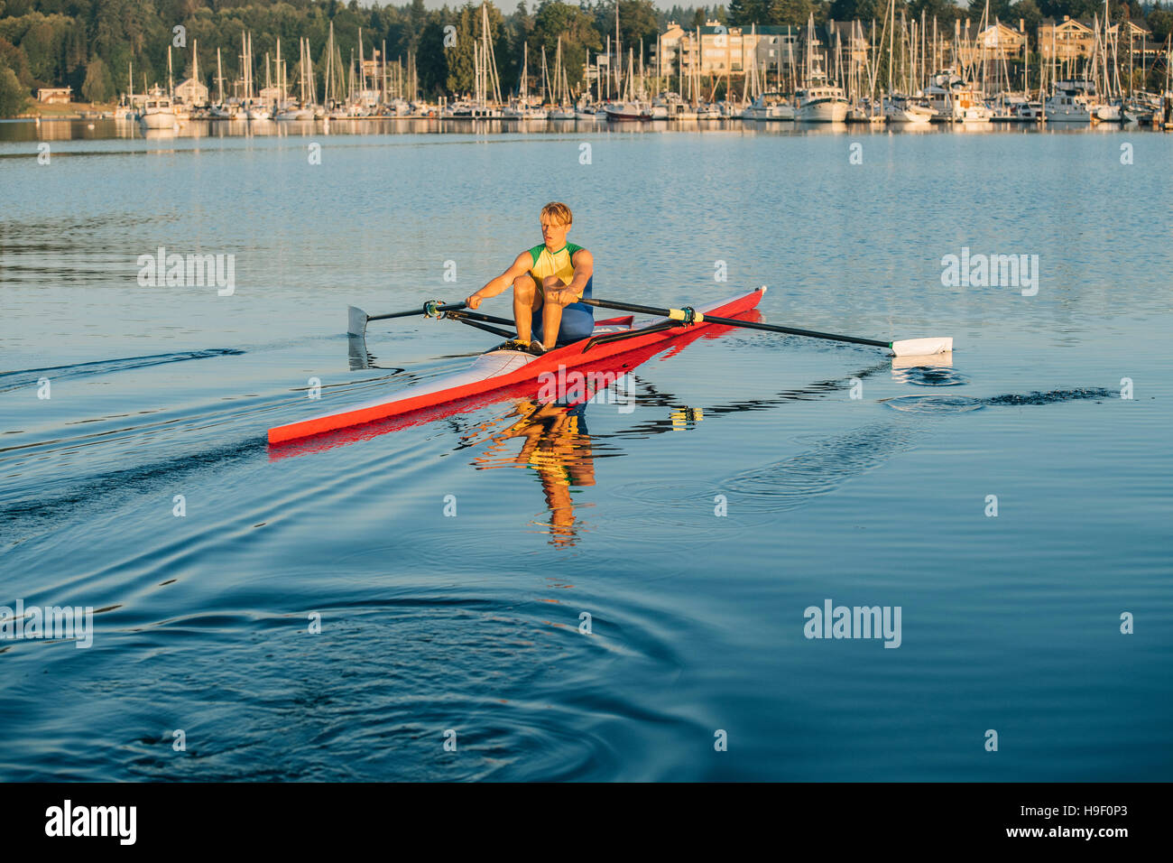 Caucasian man rowing on lake Stock Photo - Alamy
