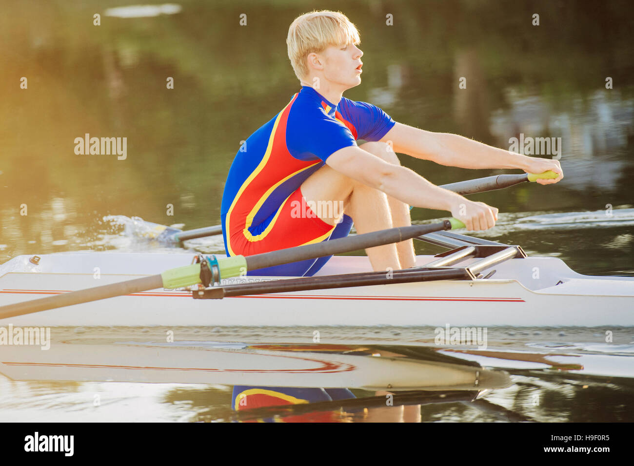 Caucasian man rowing on river Stock Photo - Alamy