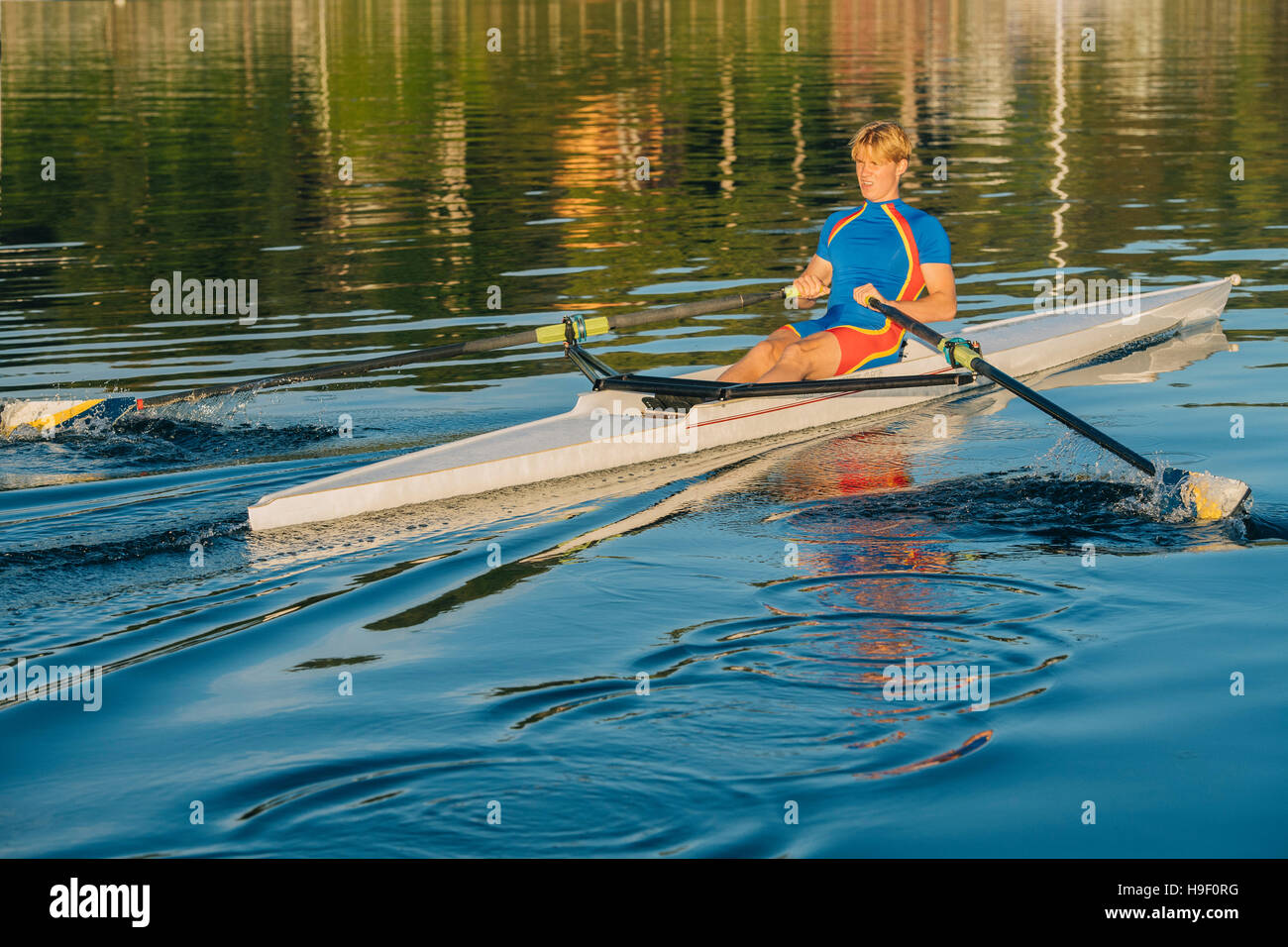 Caucasian man rowing on river Stock Photo - Alamy