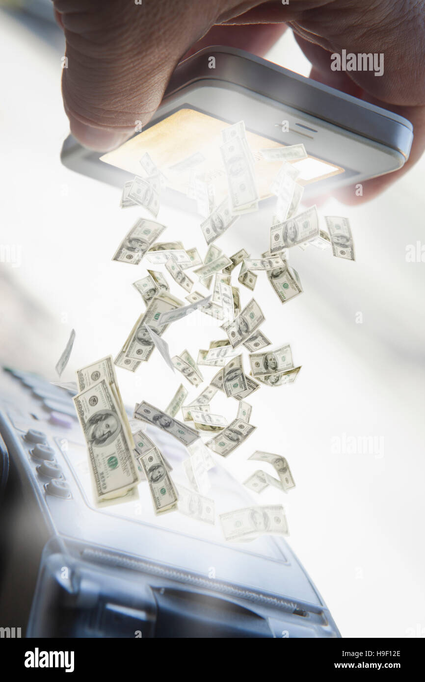 Smart phone cash money dollars hi-res stock photography and images - Alamy