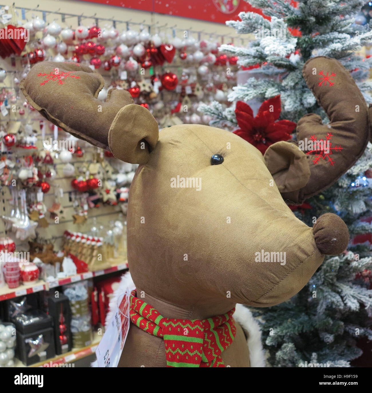 Large toy reindeer on sale in shop display at Christmas Stock Photo - Alamy