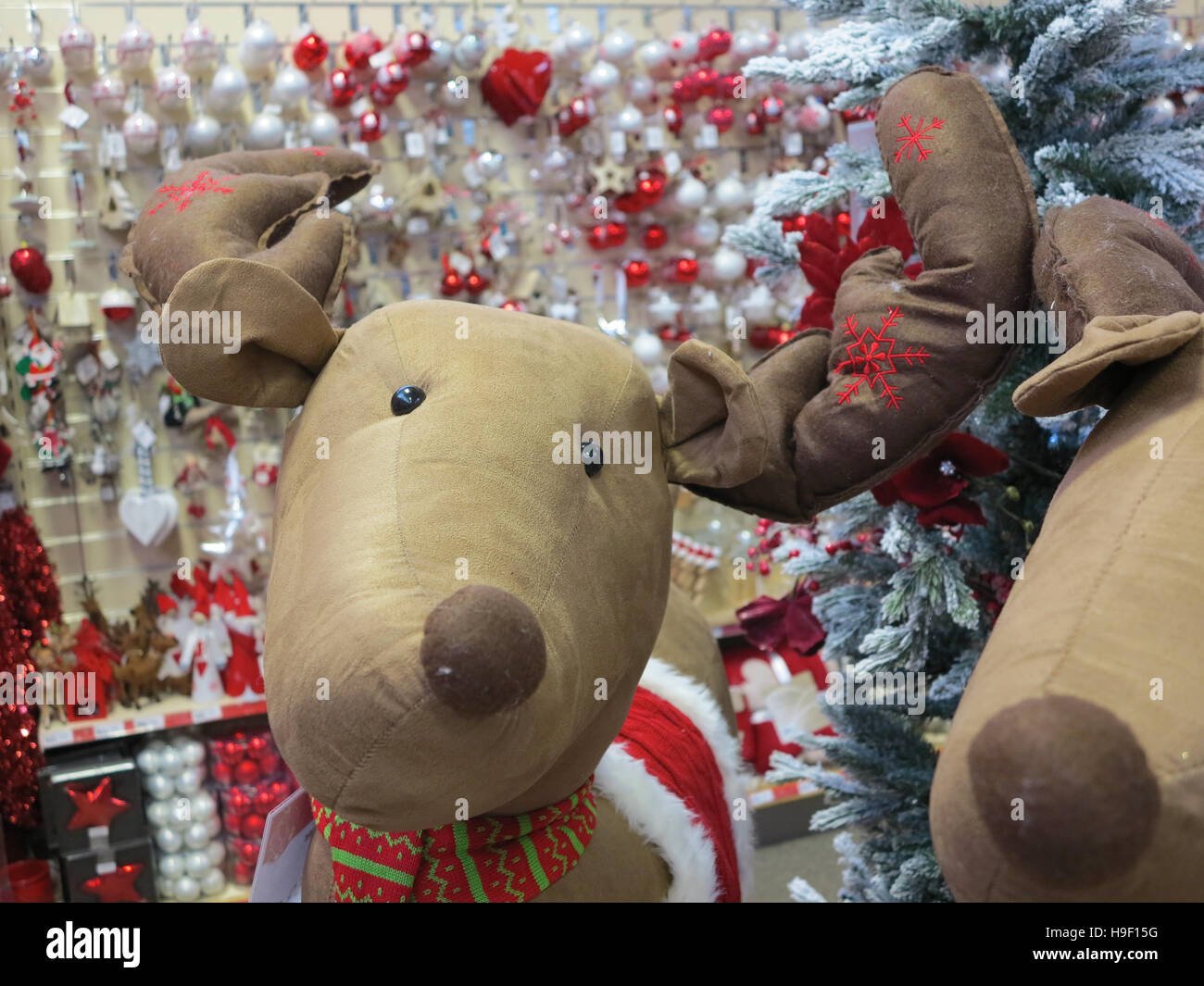 Large toy reindeer on sale in shop display at Christmas Stock Photo - Alamy