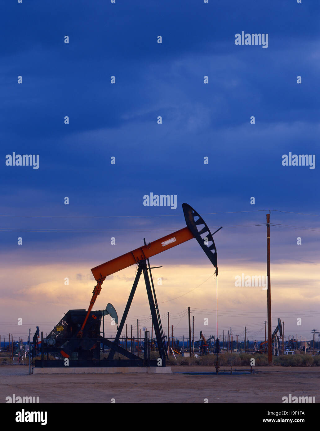 Oil rig drilling at sunset Stock Photo - Alamy