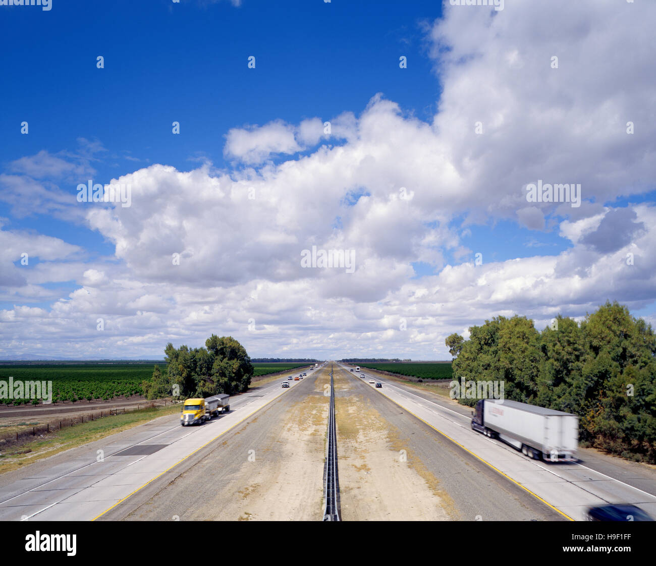 Cars and semi-trucks driving on freeway Stock Photo - Alamy
