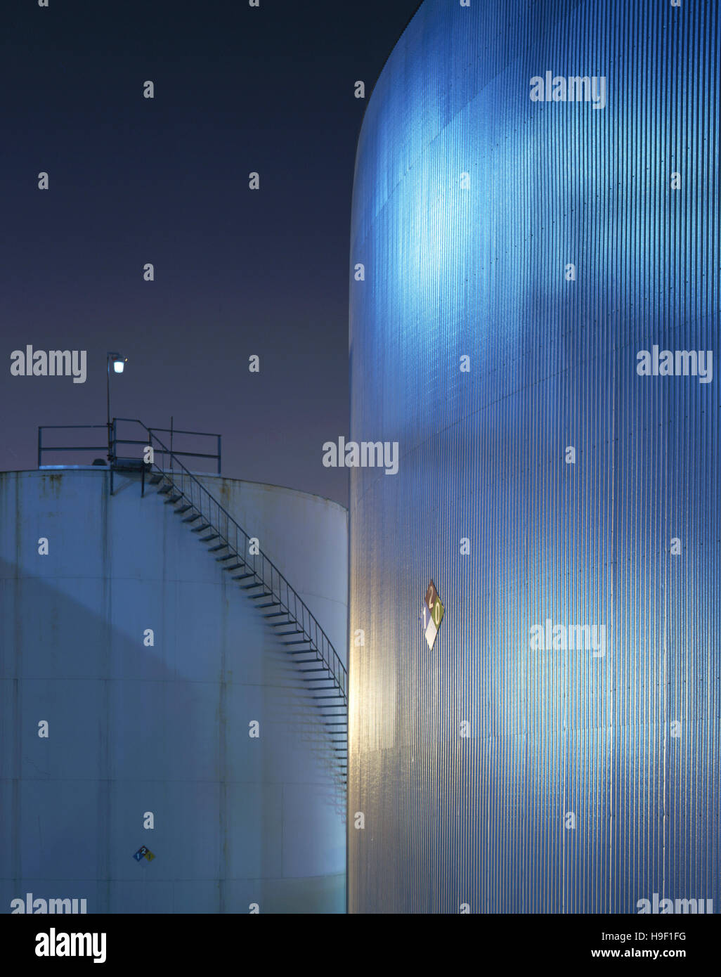 Staircase on storage tank at night Stock Photo - Alamy
