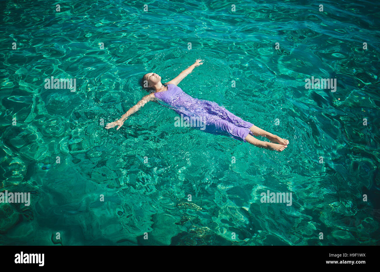 Caucasian woman wearing dress floating in water Stock Photo - Alamy
