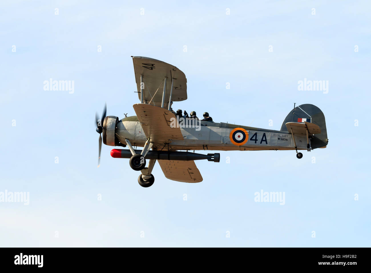 Royal Navy Fairey Swordfish biplane with two air crew saluting on fly ...