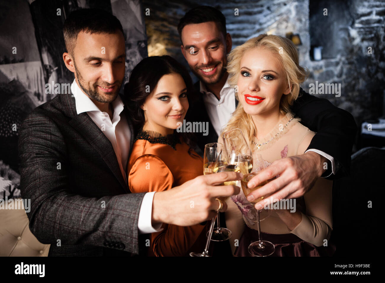 Four friends celebrating Stock Photo - Alamy