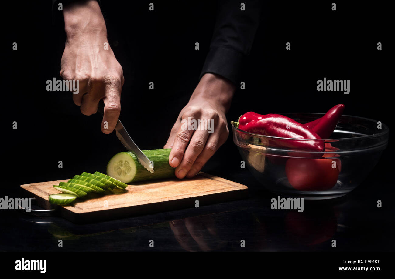 Hands male cook chopping cucumber hi-res stock photography and images ...