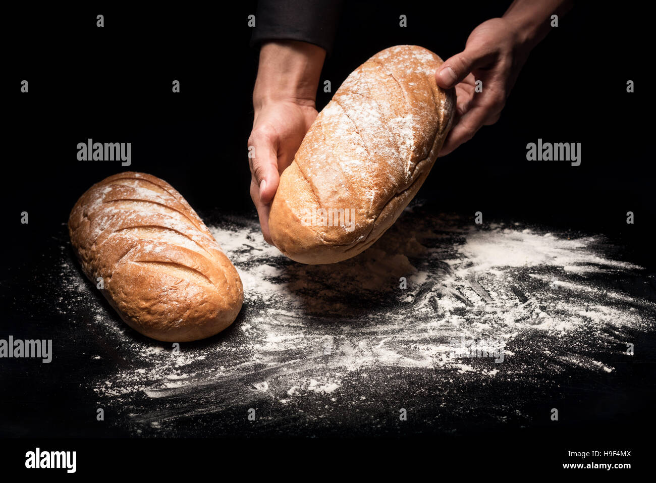 Young man is holding a loaf of bread hi-res stock photography and ...